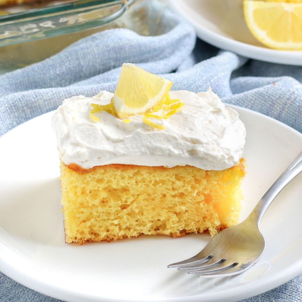 Lemon Poke Cake with Whipped Lemon Frosting - To Simply Inspire